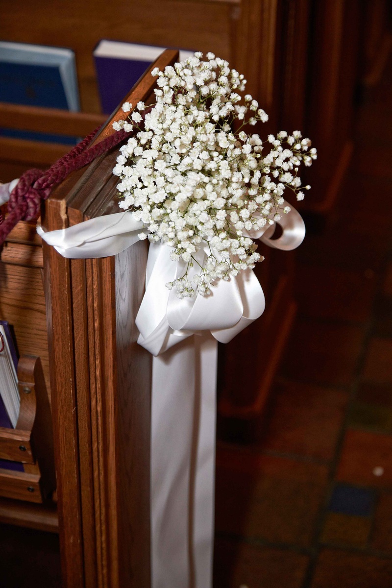 Ceremony Décor Photos - Baby's Breath on Church Pew - Inside Weddings