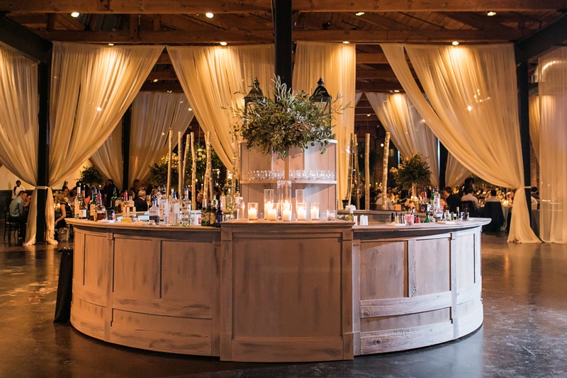 Reception Décor Photos - Round Wooden Bar - Inside Weddings