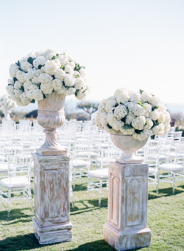 Ceremony Décor Photos - Ivory Hydrangeas in Urns - Inside Weddings